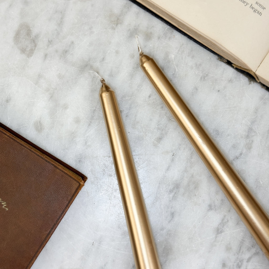 Metallic gold taper candle. – Oliver and Rust